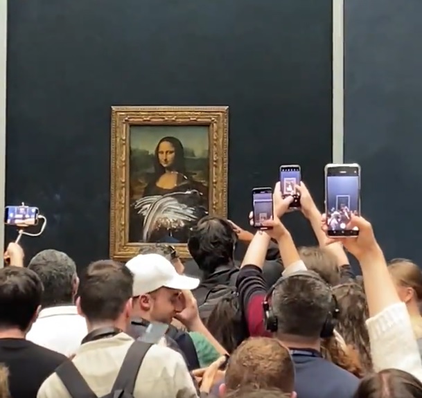 Mona Lisa 'attacked' with cake by man dressed as woman in wheelchair ...